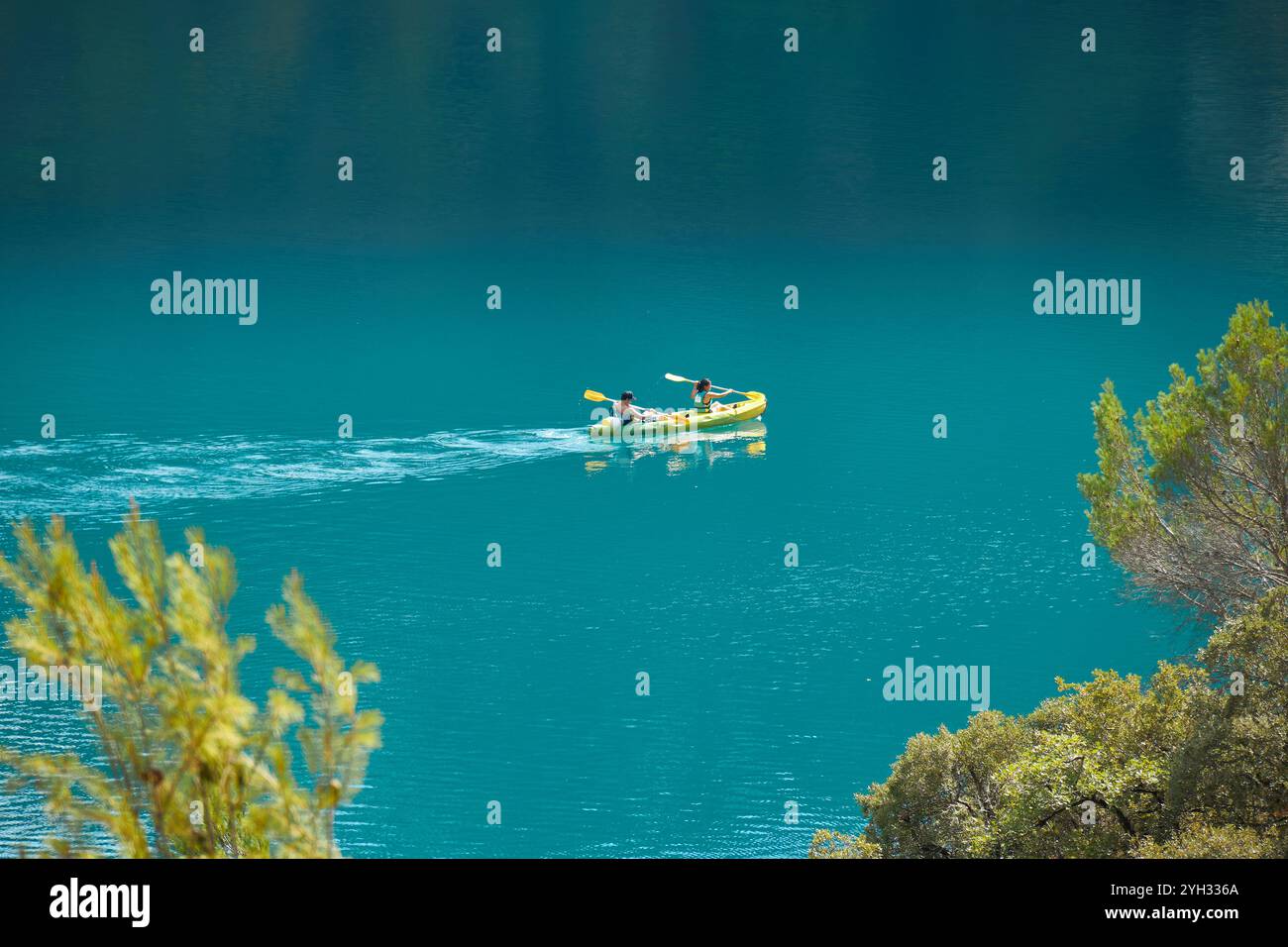 Two People Canoeing in the cyan waters of Lake Esparron in the Gorges ...