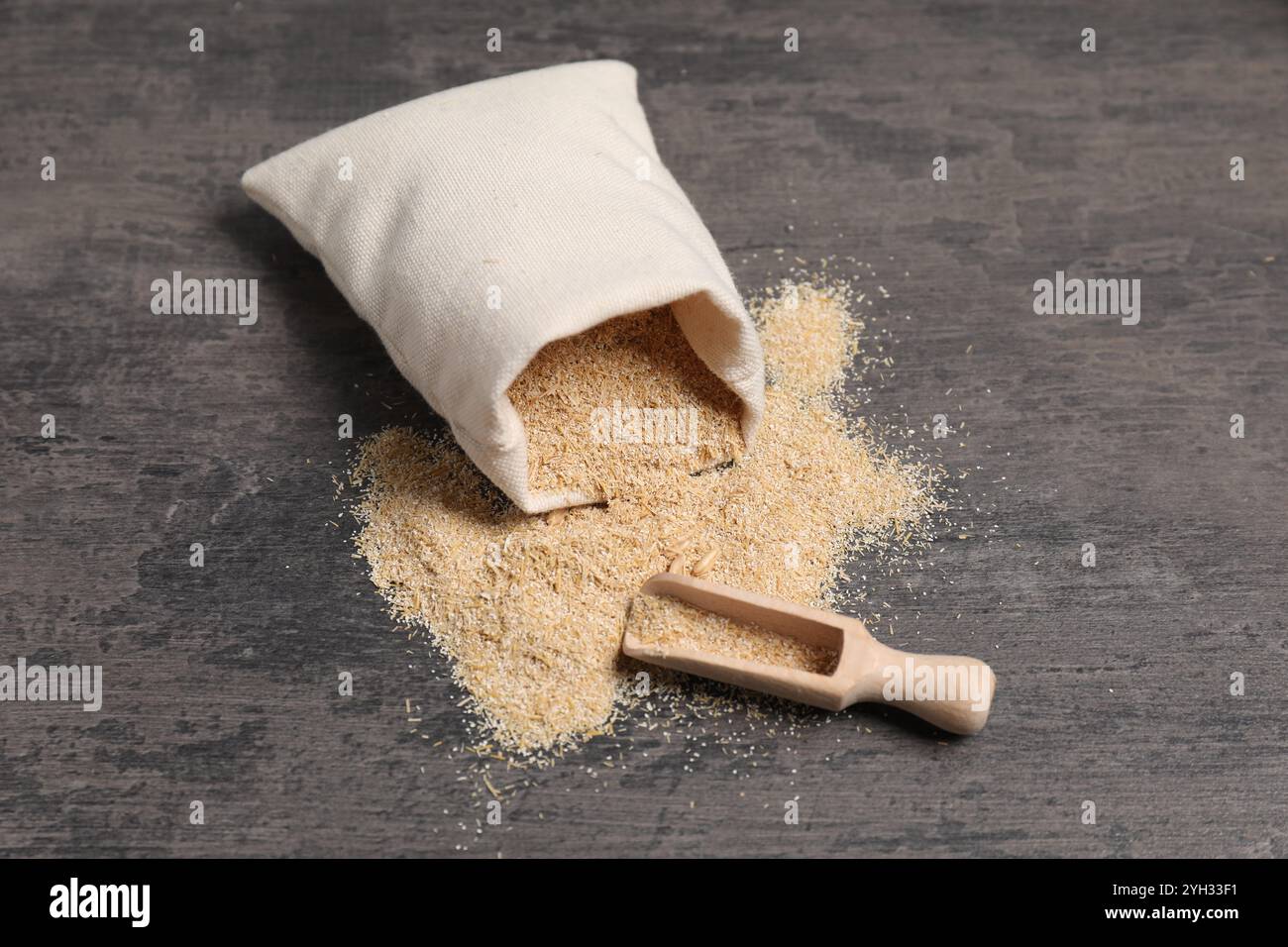 Oat bran in burlap bag and wooden scoop on grey table Stock Photo - Alamy