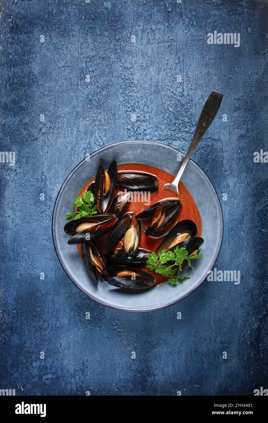 Fra Diavolo mussels, mussels in tomato sauce, Italian dish, on a blue ...