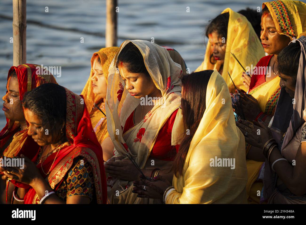 Hindu devotees perform rituals as they offer prayers to the Sun god in ...