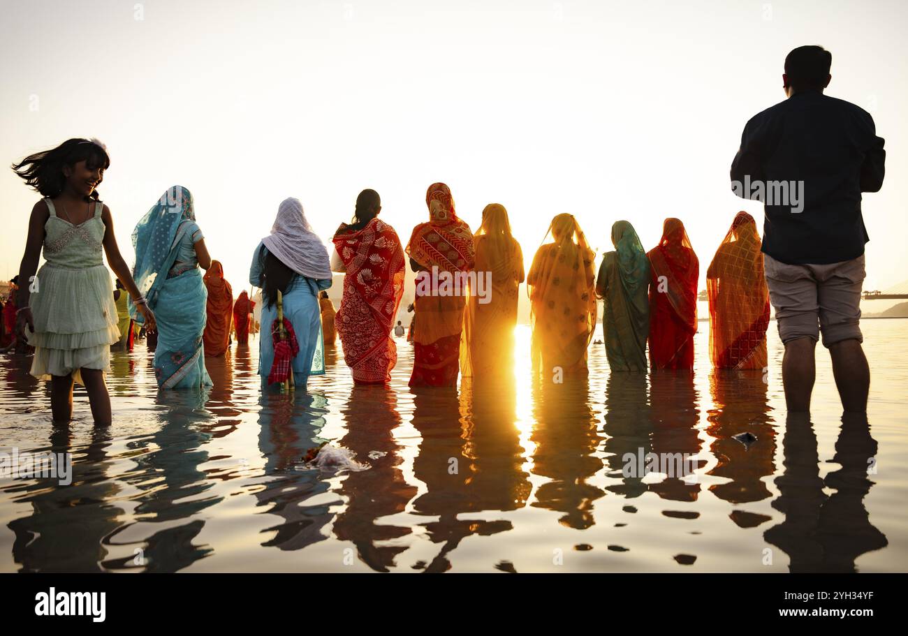 Hindu devotees perform rituals as they offer prayers to the Sun god in ...