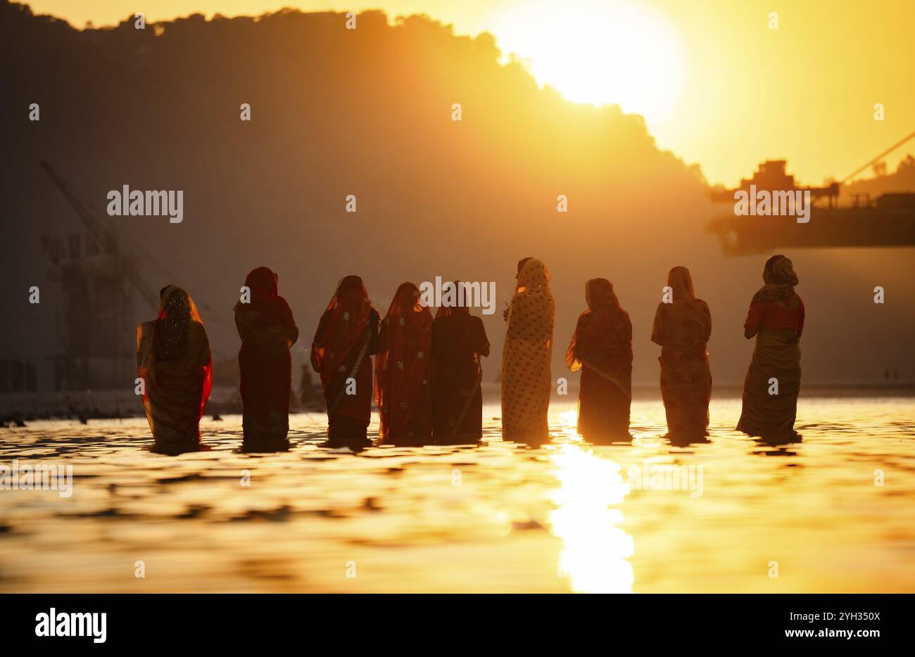 Hindu devotees perform rituals as they offer prayers to the Sun god in ...