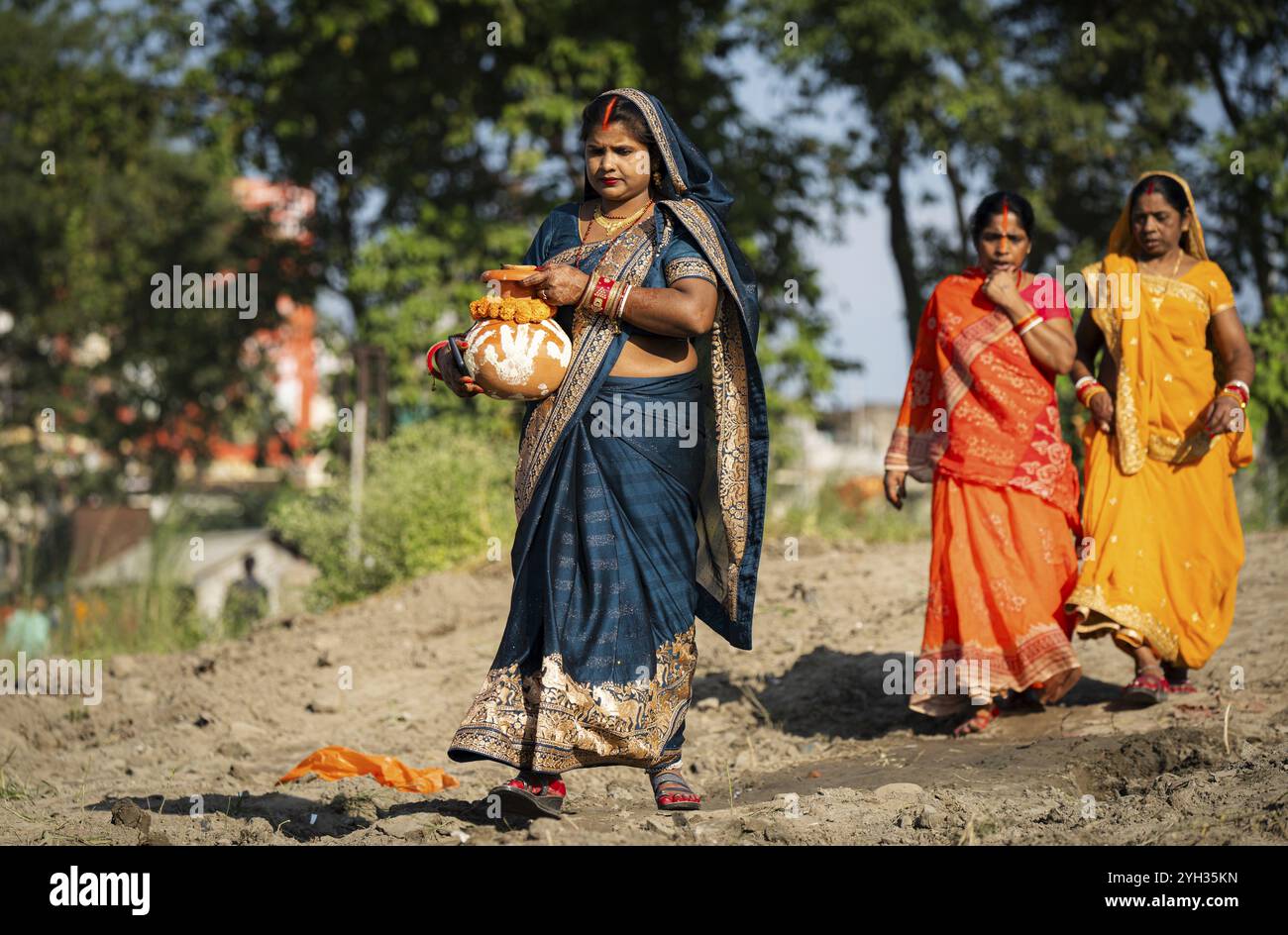 Hindu devotees perform rituals as they offer prayers to the Sun god in ...