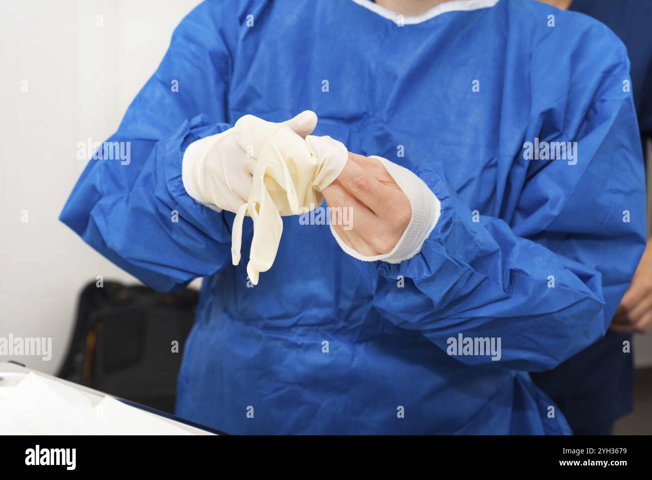 Nurse putting on surgical gloves Stock Photo - Alamy