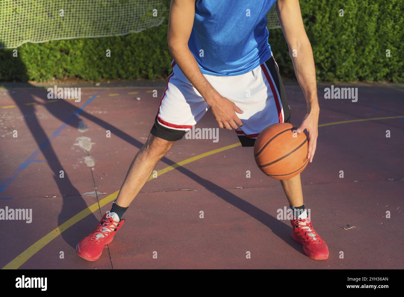 Young man athlete on basketball court dribbling Stock Photo - Alamy