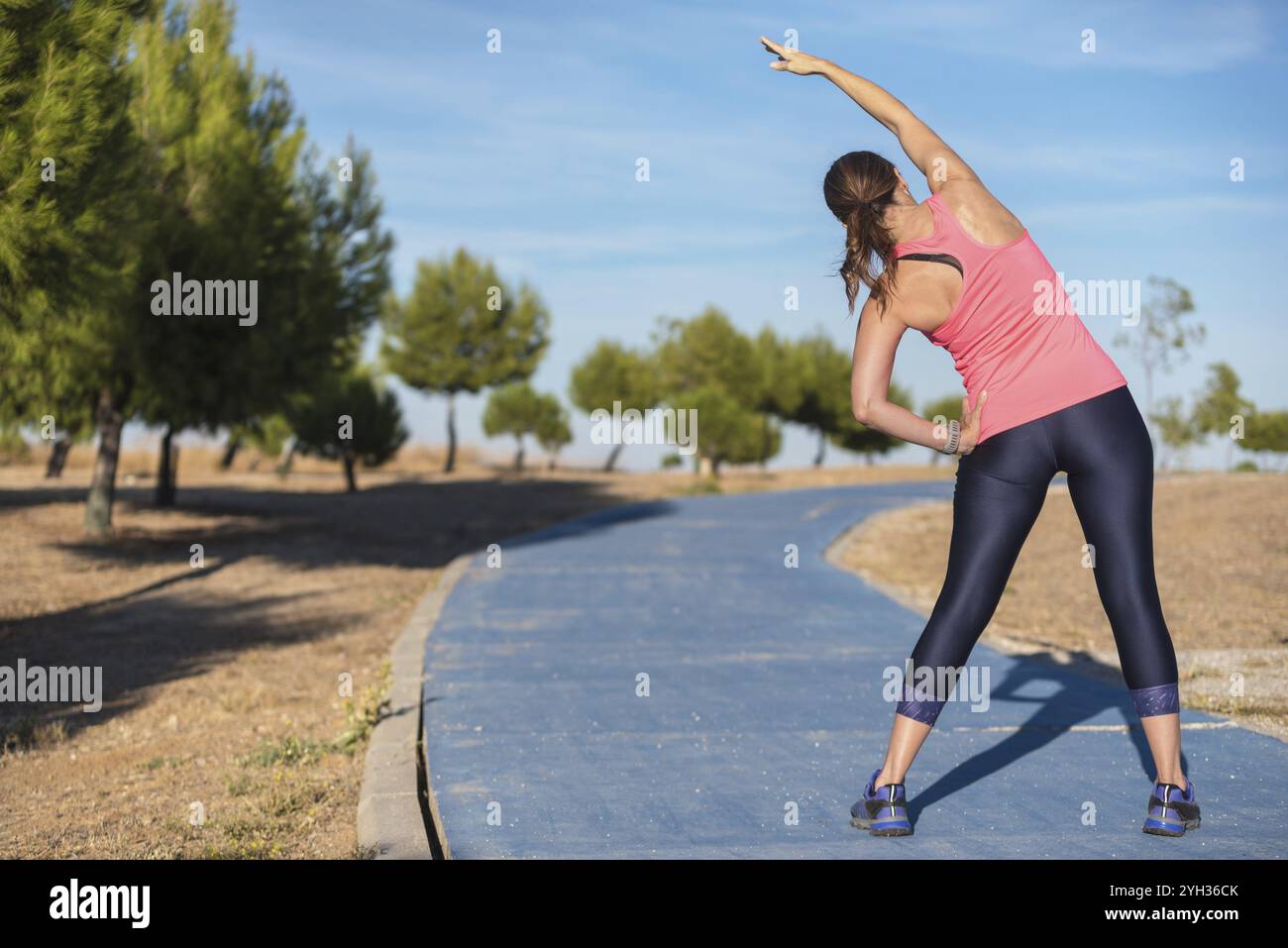 Woman doing stretching exercise for back, sport background Stock Photo ...