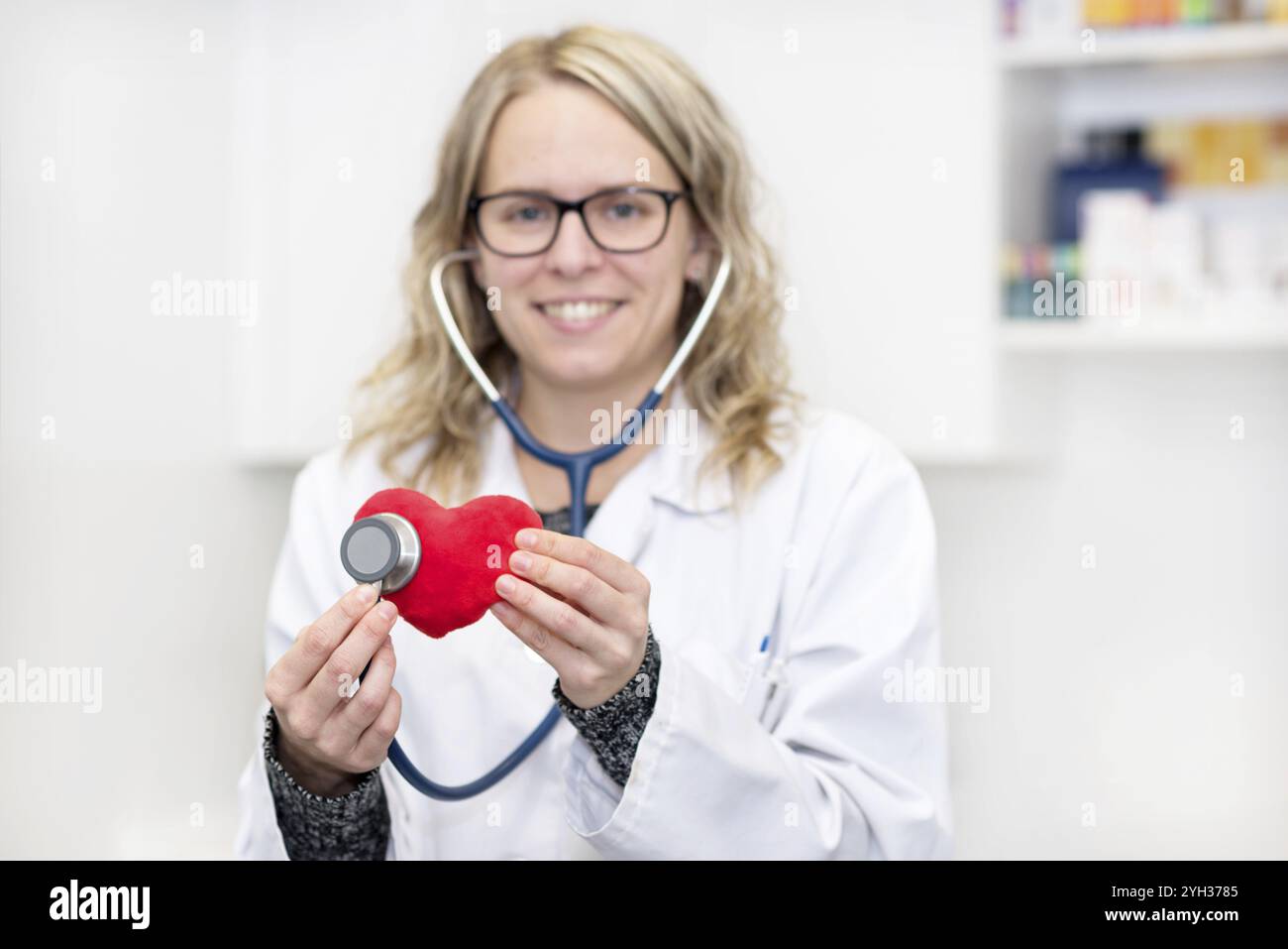 Cardiologist doctor. checking heart with stethoscope Stock Photo - Alamy