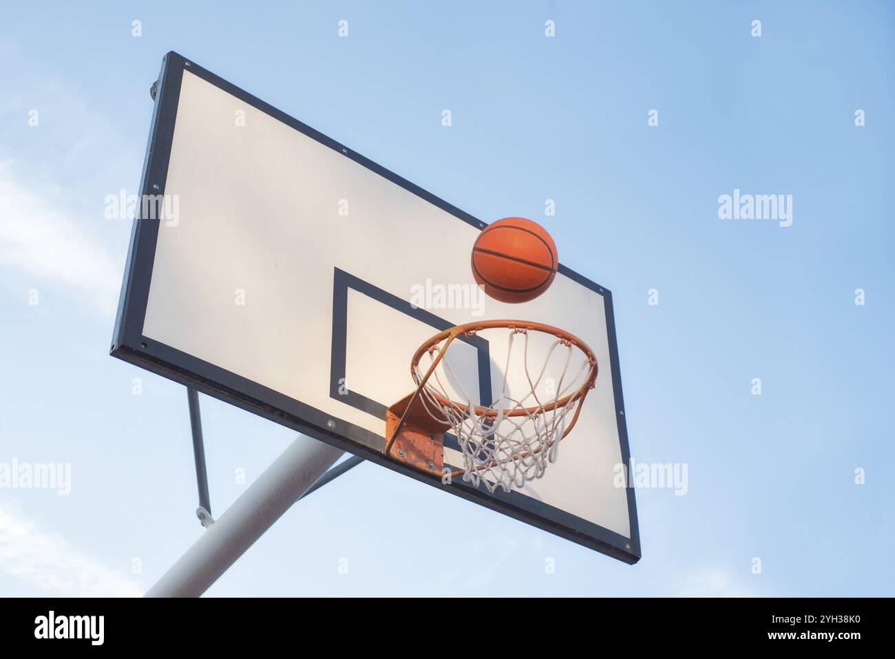 Basketball court goal with blue sky background Stock Photo - Alamy