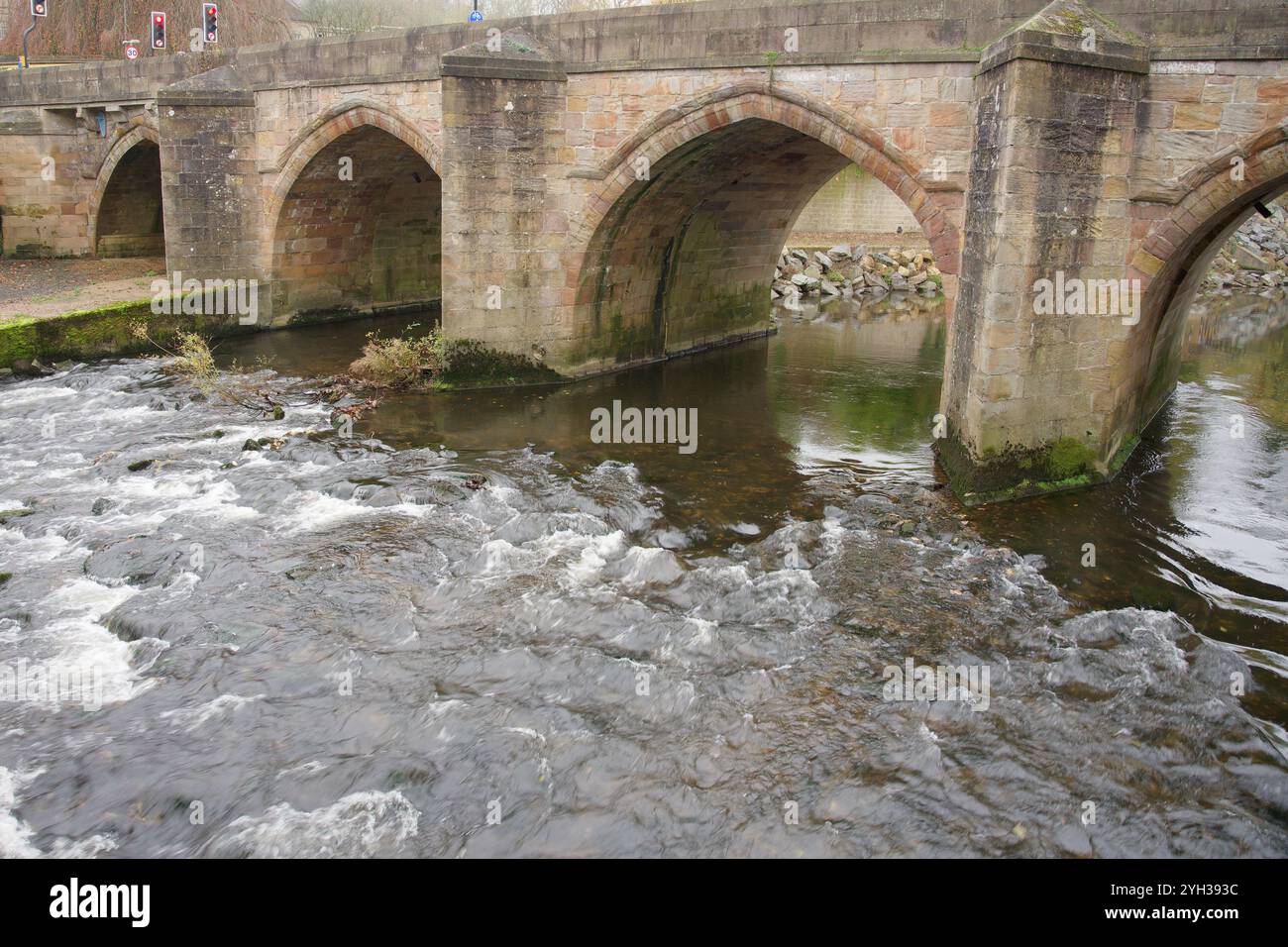 Water flowing under an arched stone bridge in Matlock, Derbyshire, UK ...