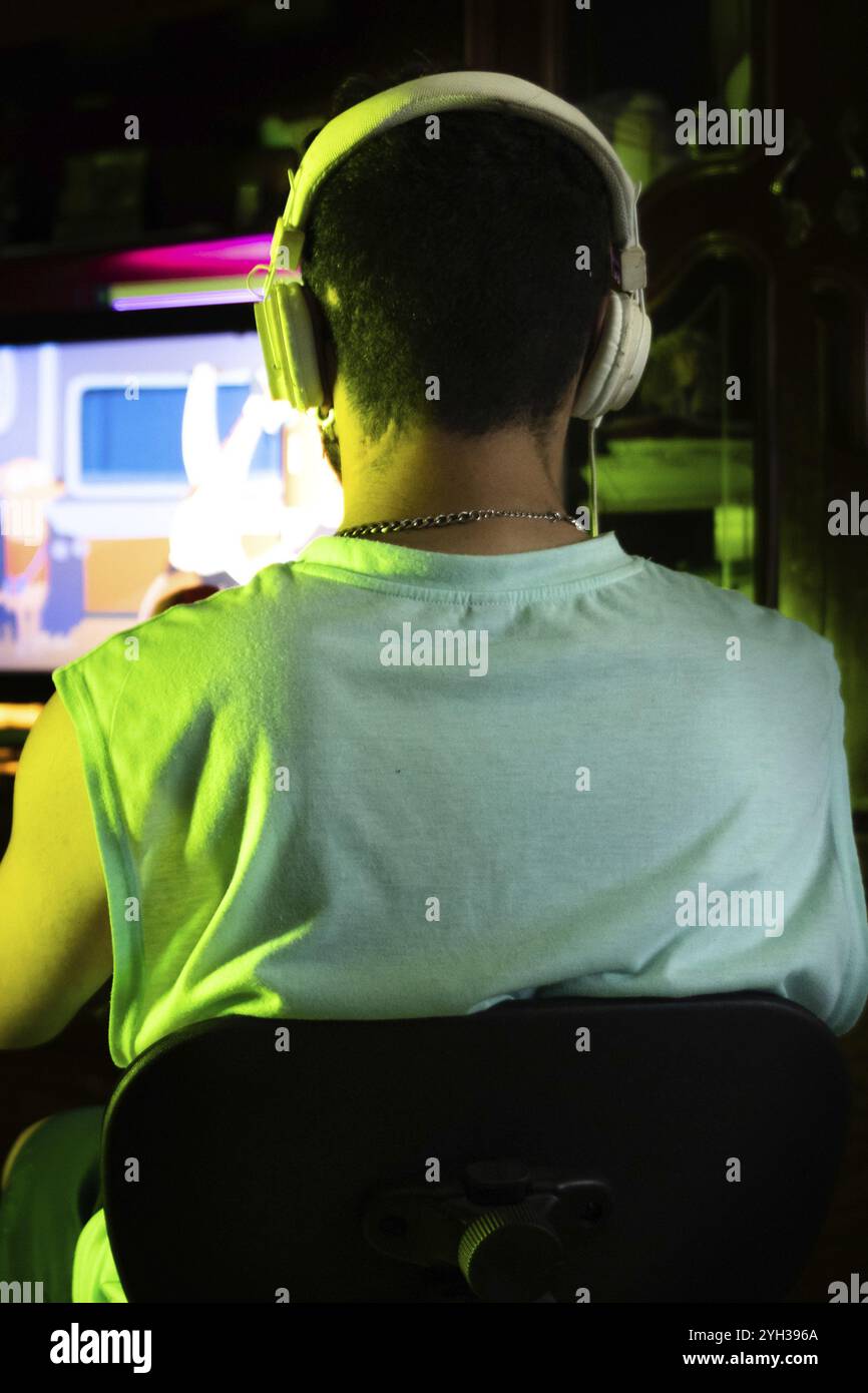 Gamer playing video games at home while streaming his games online and ...