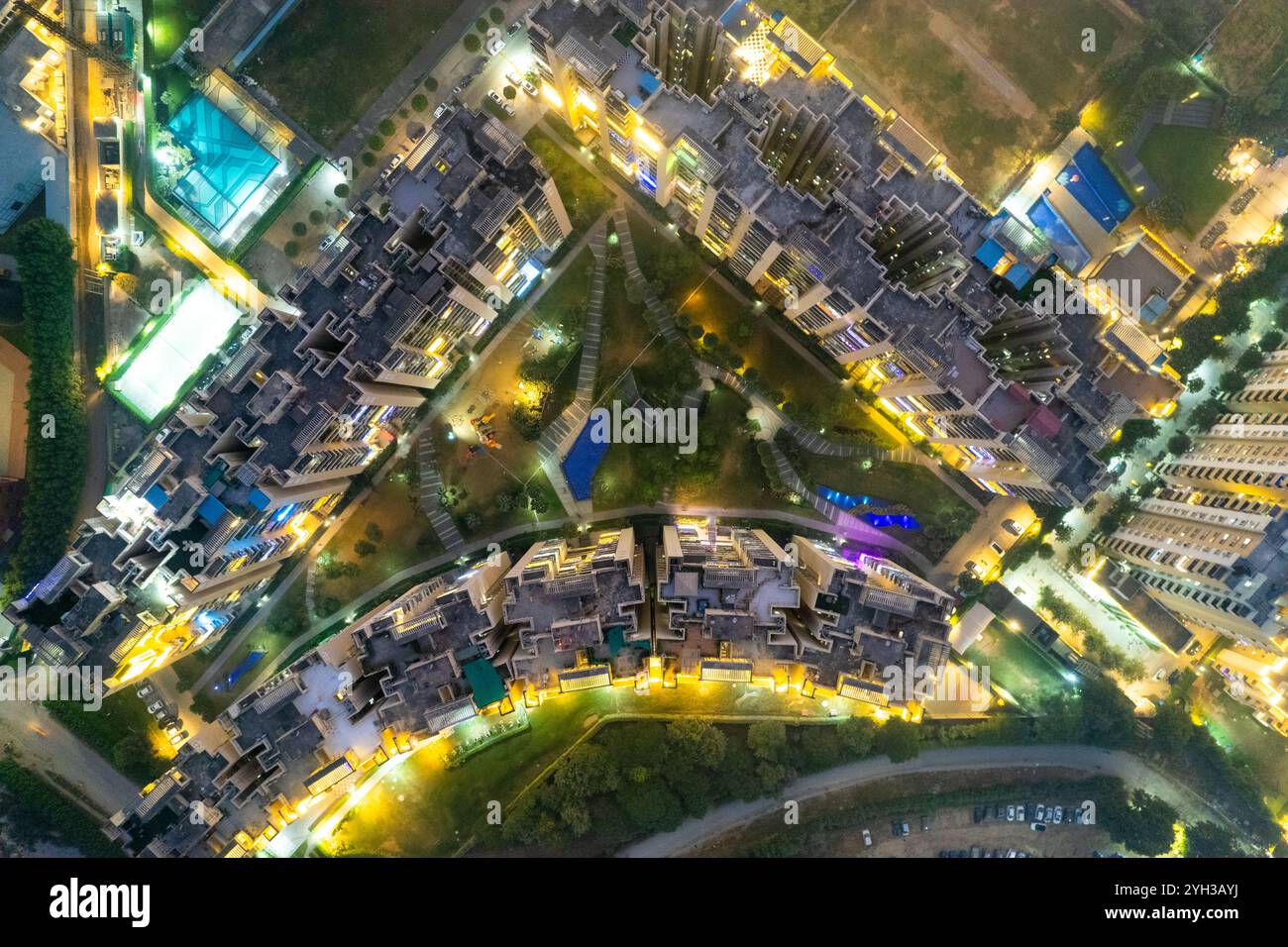 aerial drone shot looking straight down at park between three high rise ...