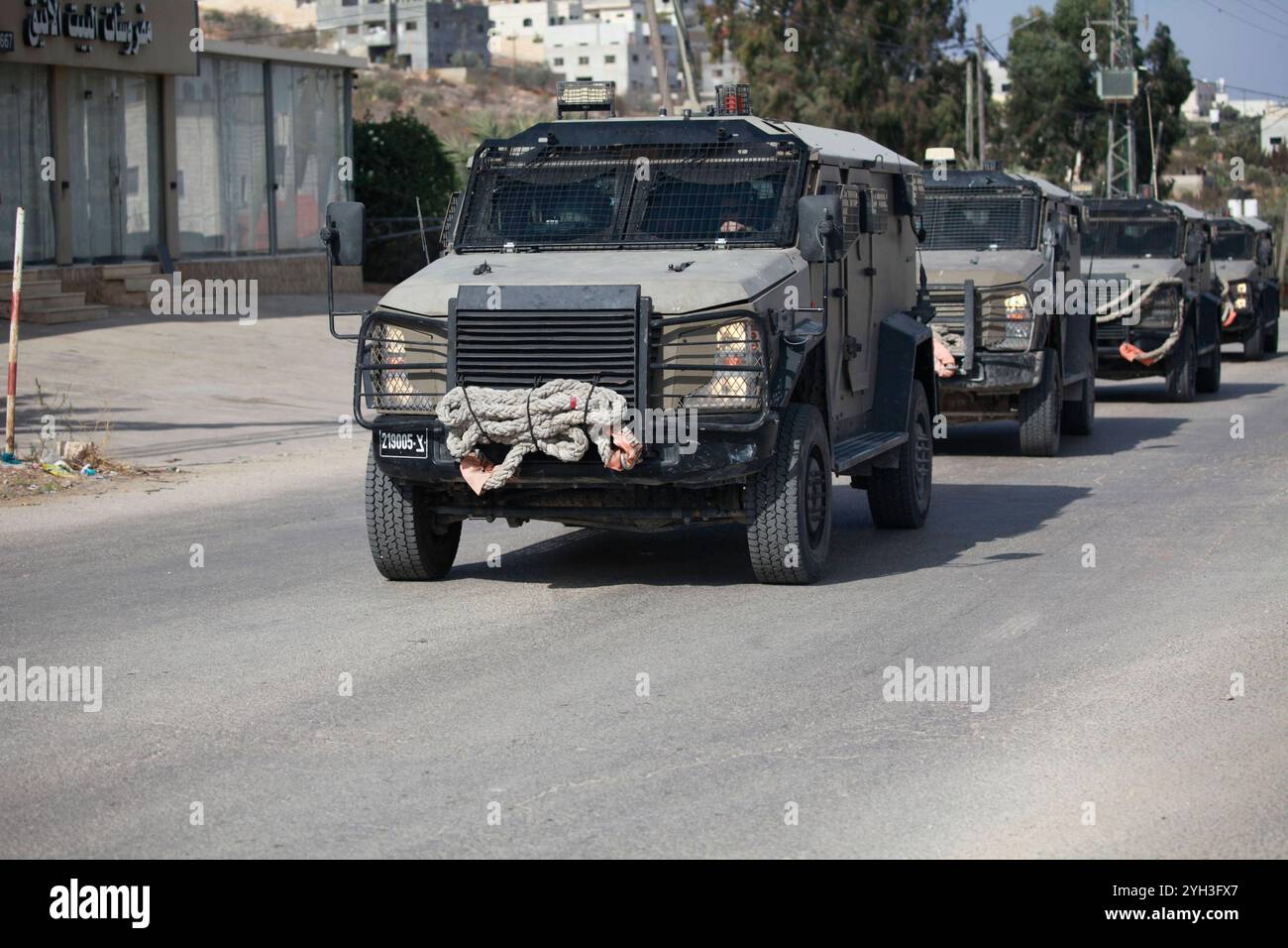 Israeli military vehicles close the street and surround a house where ...