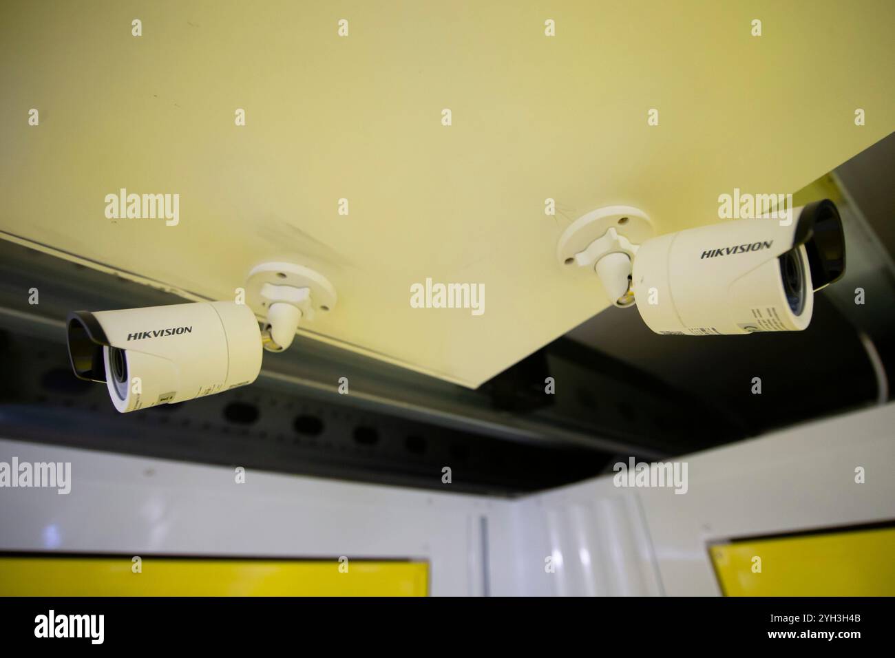 Security camera mounted in a self-storage facility hallway with yellow ...