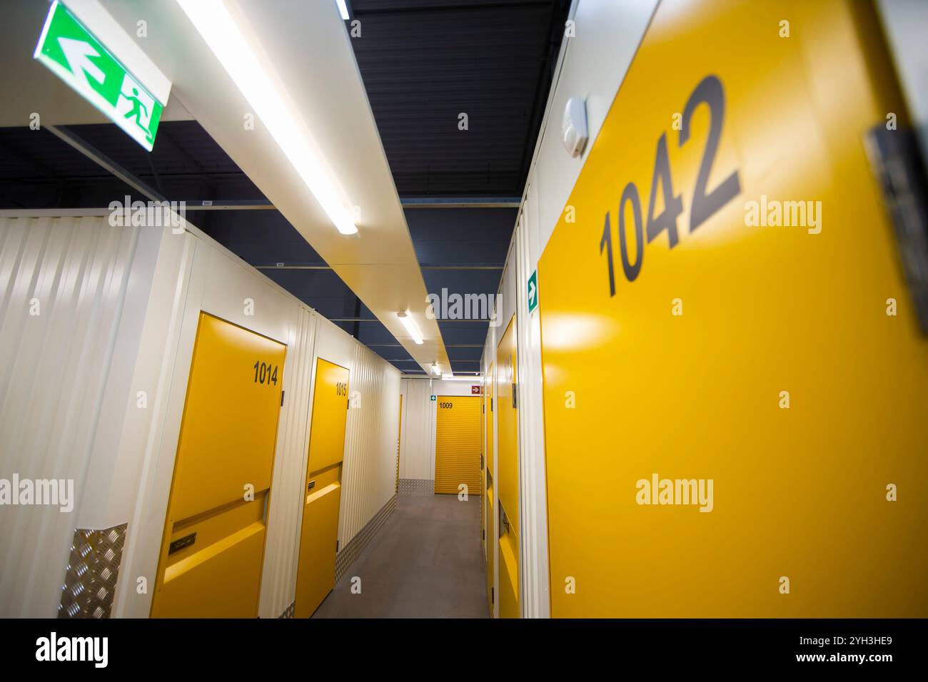 Numbered yellow storage lockers in a well-lit facility, offering secure ...