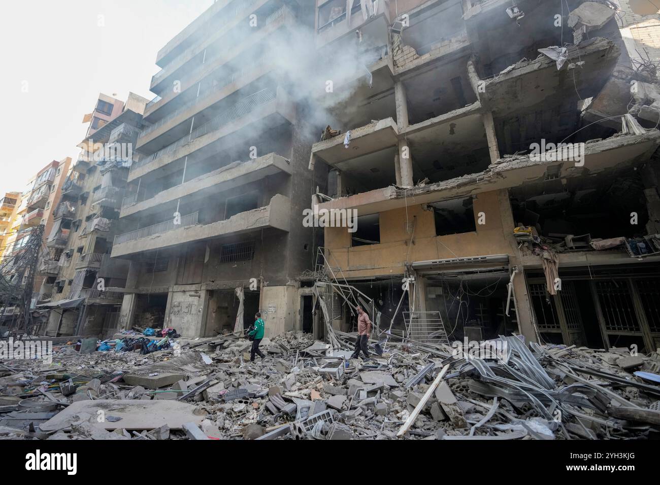 Residents check the site of an Israeli airstrike in Dahiyeh, Beirut ...