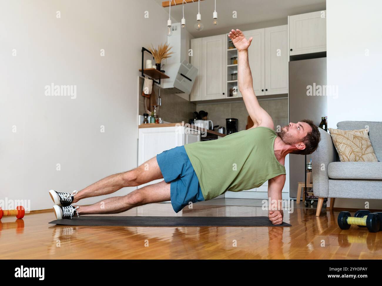 Man doing side plank exercise for core strength at home Stock Photo - Alamy