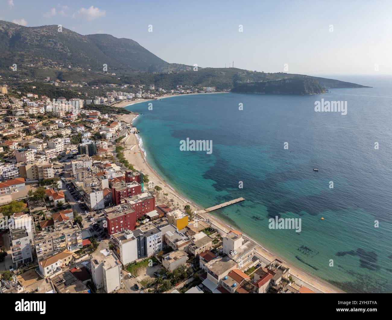 Aerial drone photo of the coastal town of Himarë in Albania. Himarë has ...