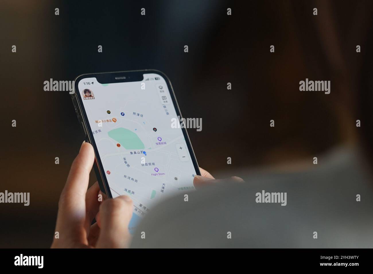 In this photo illustration, A woman browses the Baidu Maps APP to view her location on her ...