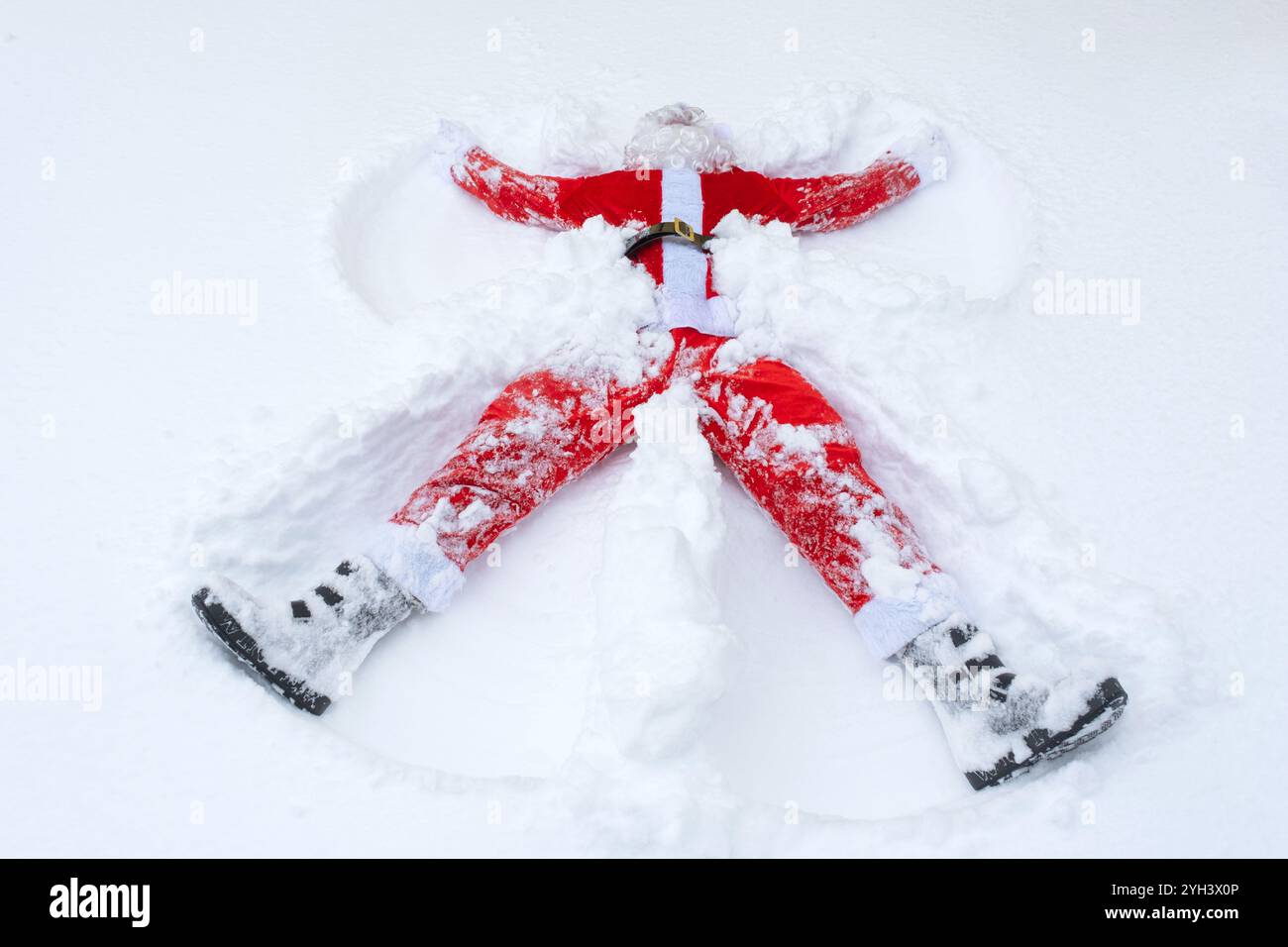 Santa Claus makes snow angels in the snow. Humor, winter fun, Santa is ...