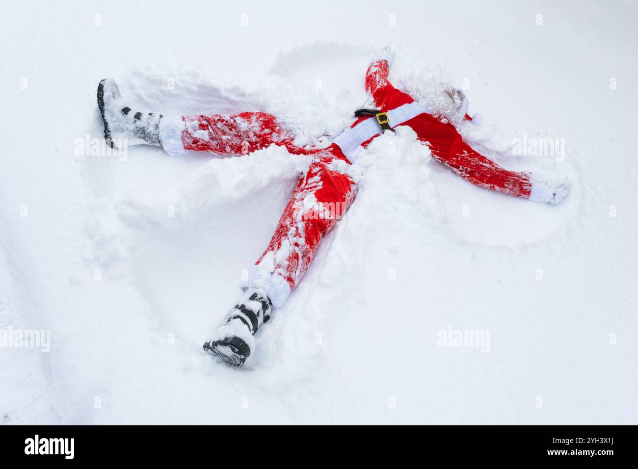 Santa Claus makes snow angels in the snow. Humor, winter fun, Santa is ...