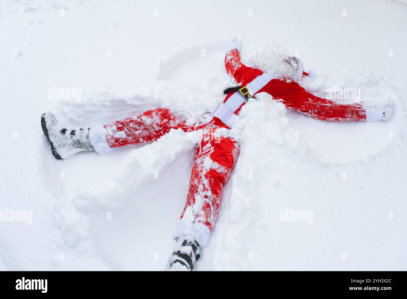 Santa Claus makes snow angels in the snow. Humor, winter fun, Santa is ...