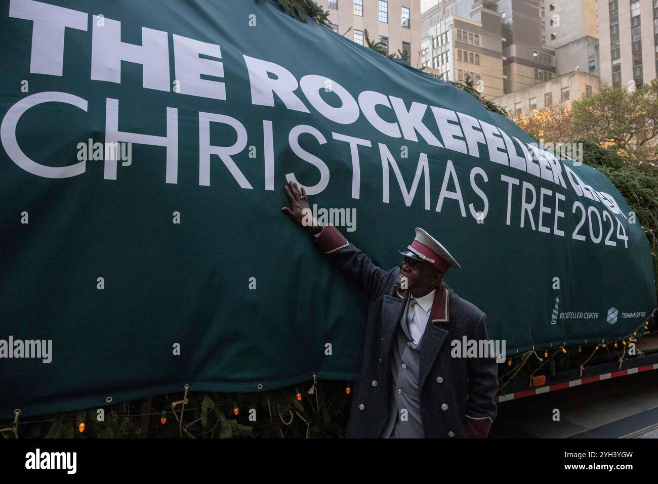 An employee touches the Rockefeller Center Christmas tree at ...
