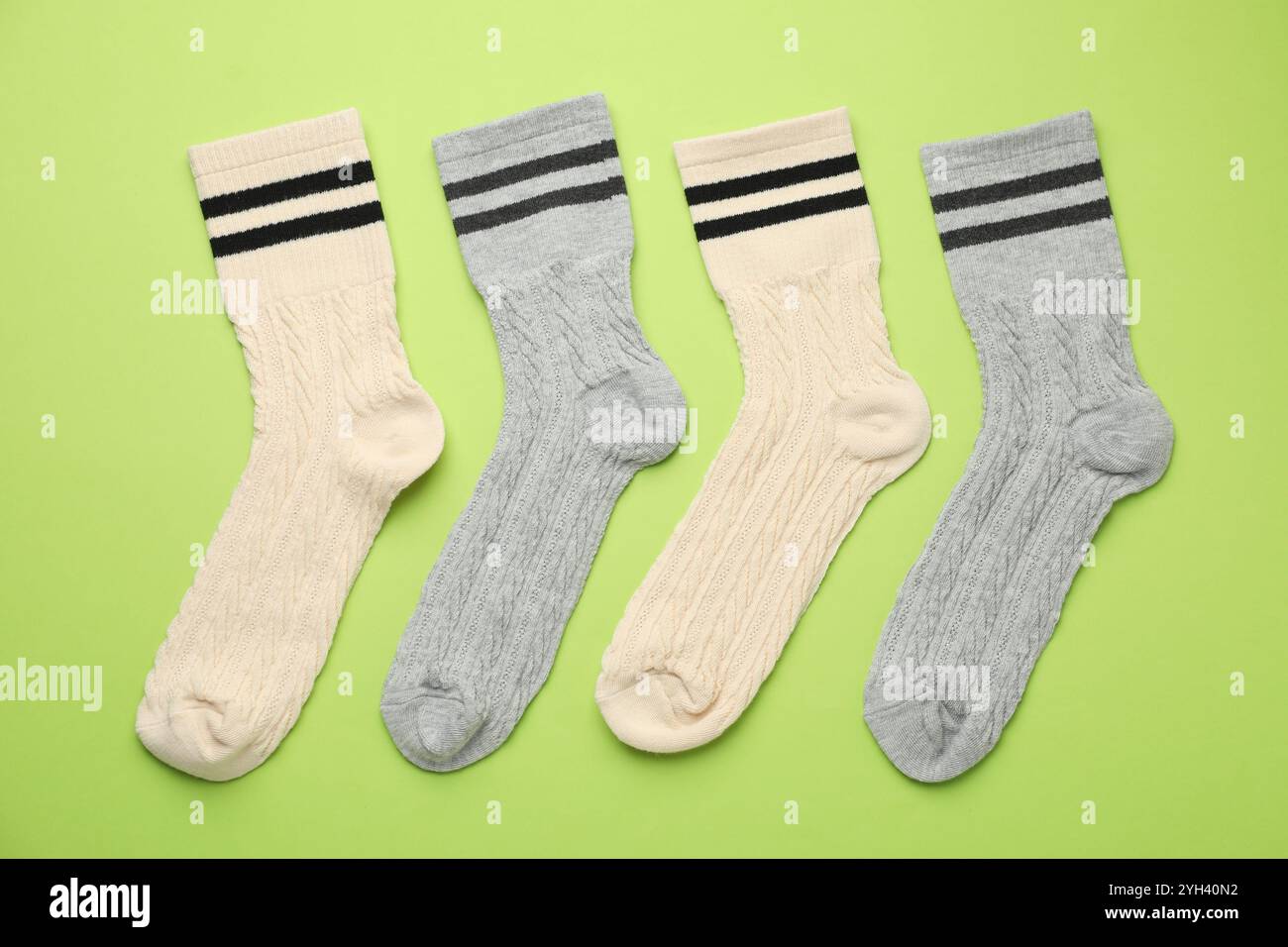 Different comfortable socks on light green background, flat lay Stock ...