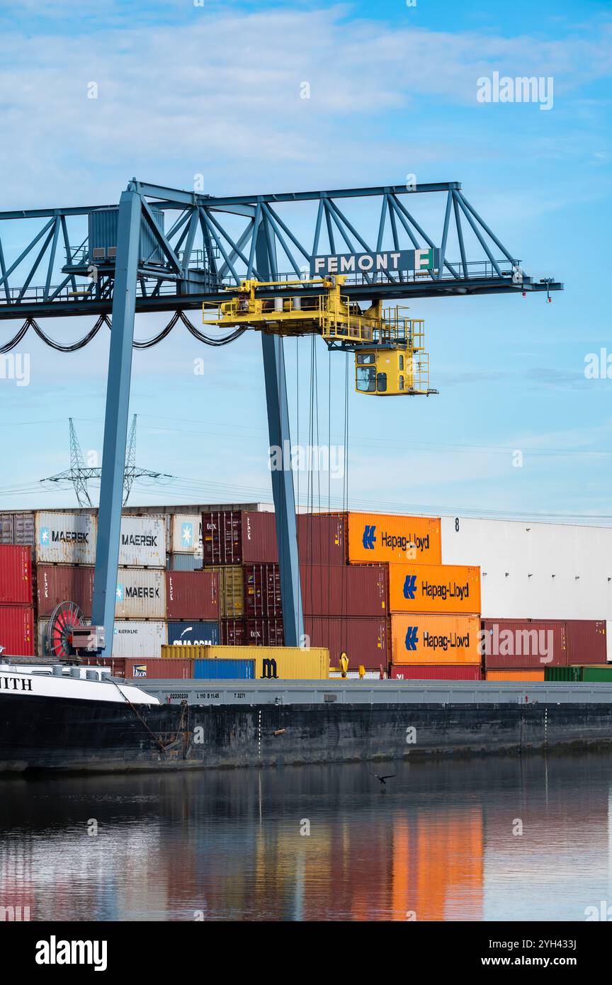 Industrial cranes and container at a logistic dock and loading center ...