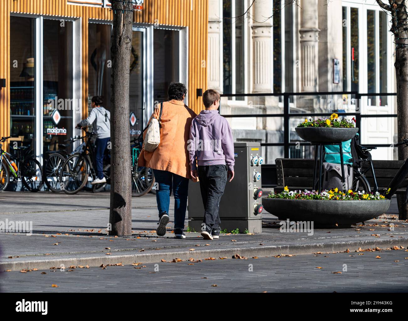 Mother with teenage son walking over the old market square in Vilvoorde ...