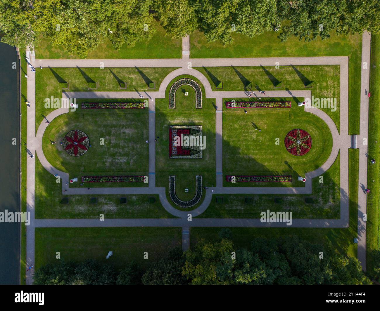 An aerial view of a symmetrical garden with paths, flowerbeds, and ...