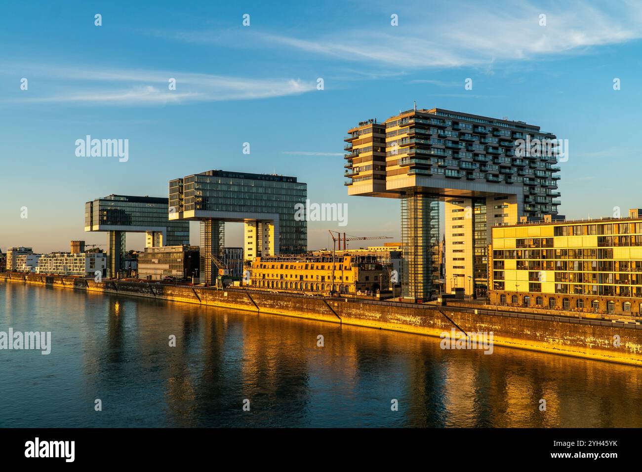 A modern cityscape featuring three unique crane-shaped buildings along ...