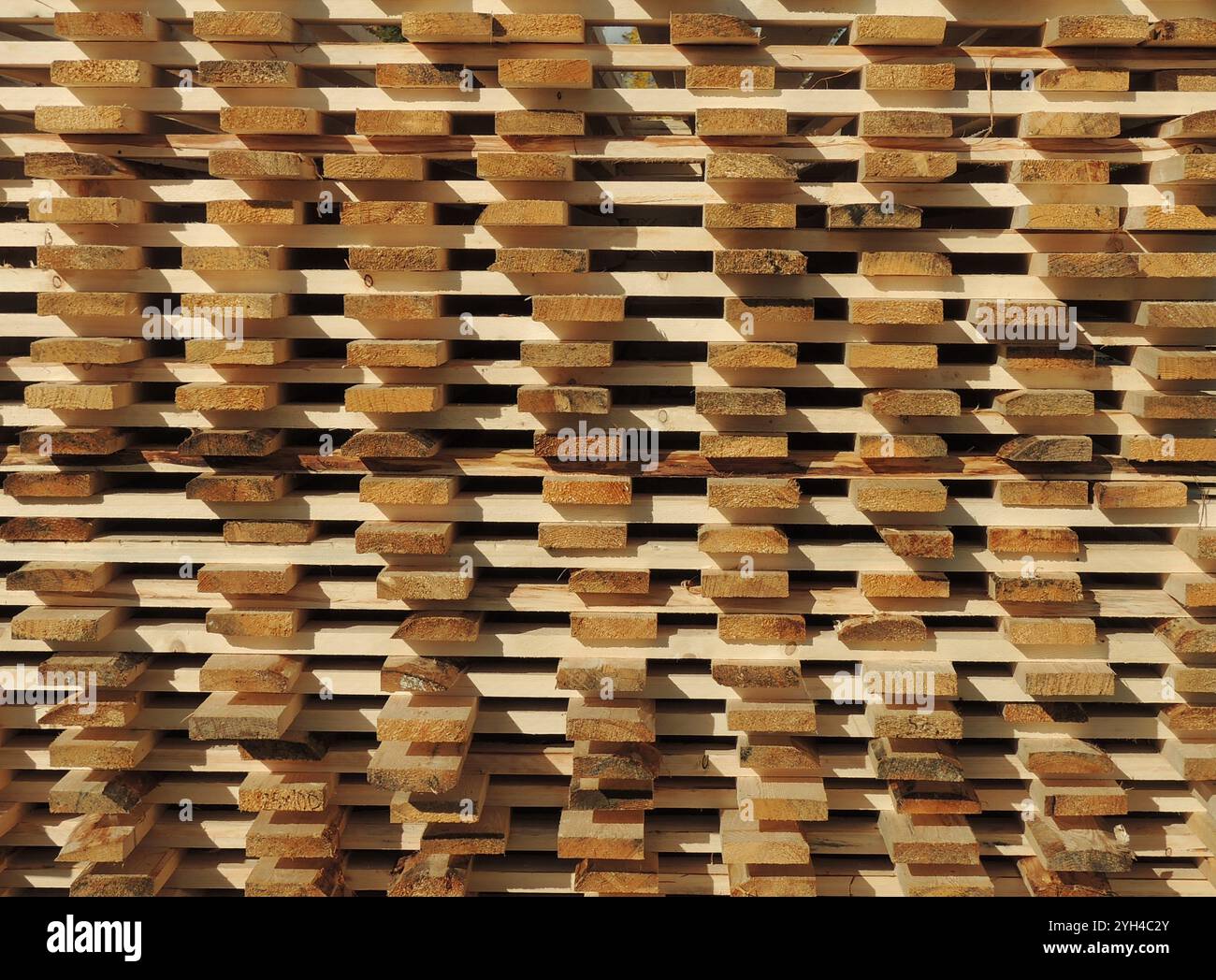 planed boards lying on top of each other in layers, forming a natural ...