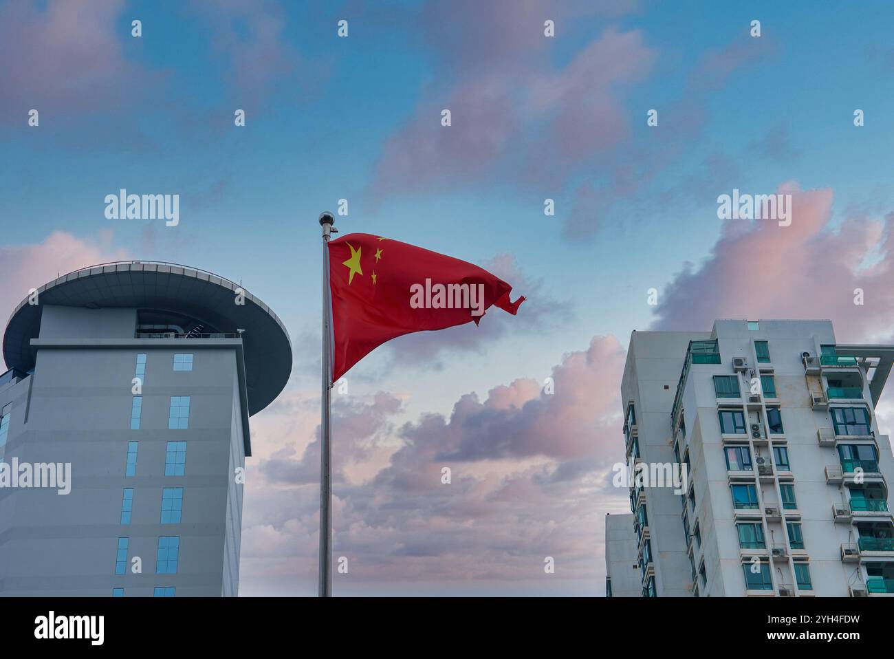 Chinese Flag Waving Against Vibrant Sky in Urban Shanghai Setting Stock ...