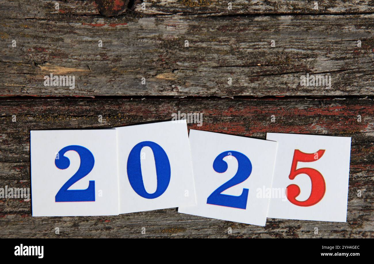 Numbers of 2025 year. Paper square numbers on the wooden background ...