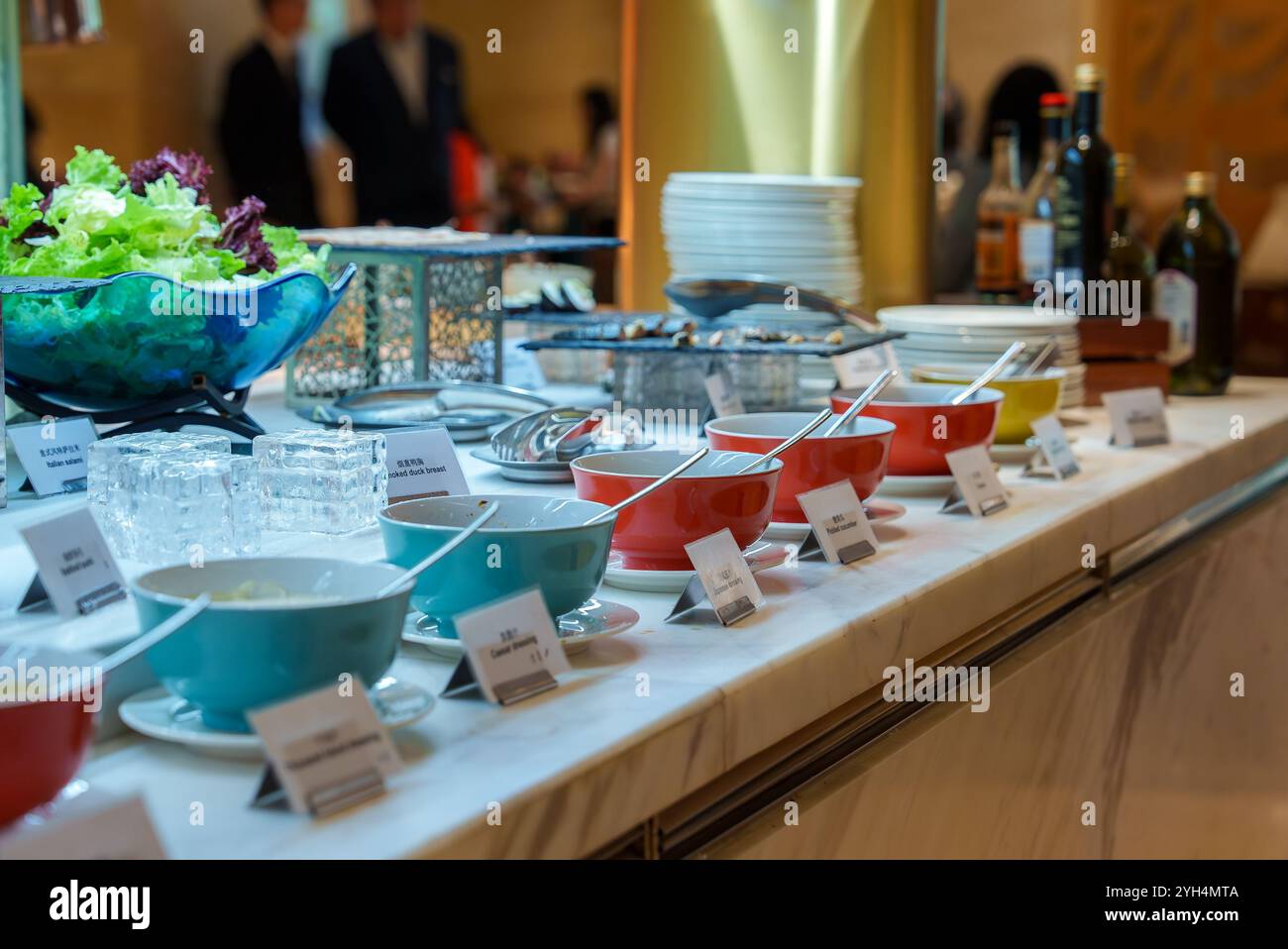 Buffet Setup with Colorful Bowls and Fresh Lettuce on Marble Countertop ...