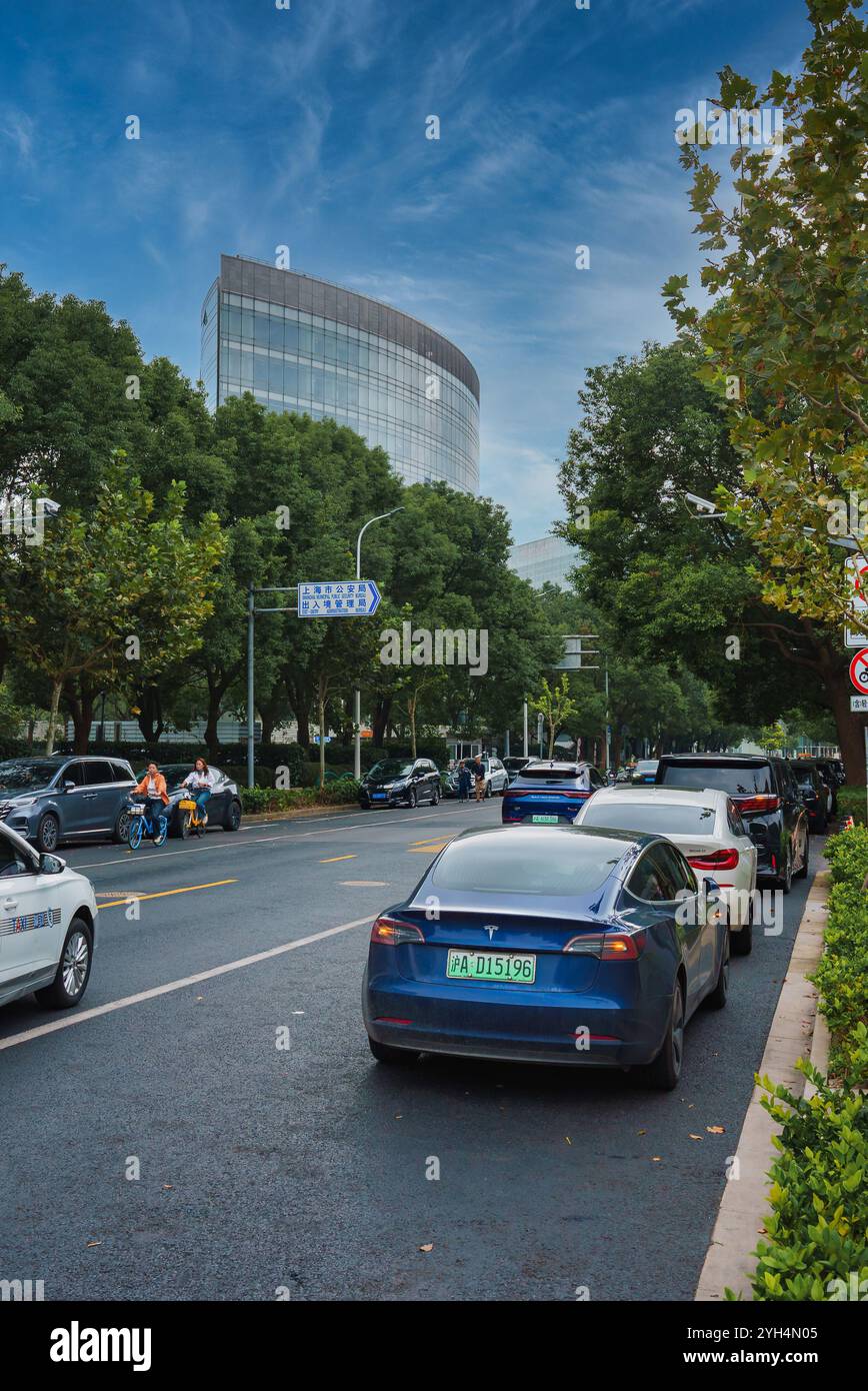 Street Scene in Shanghai with Curved Glass Building and Blue Tesla ...
