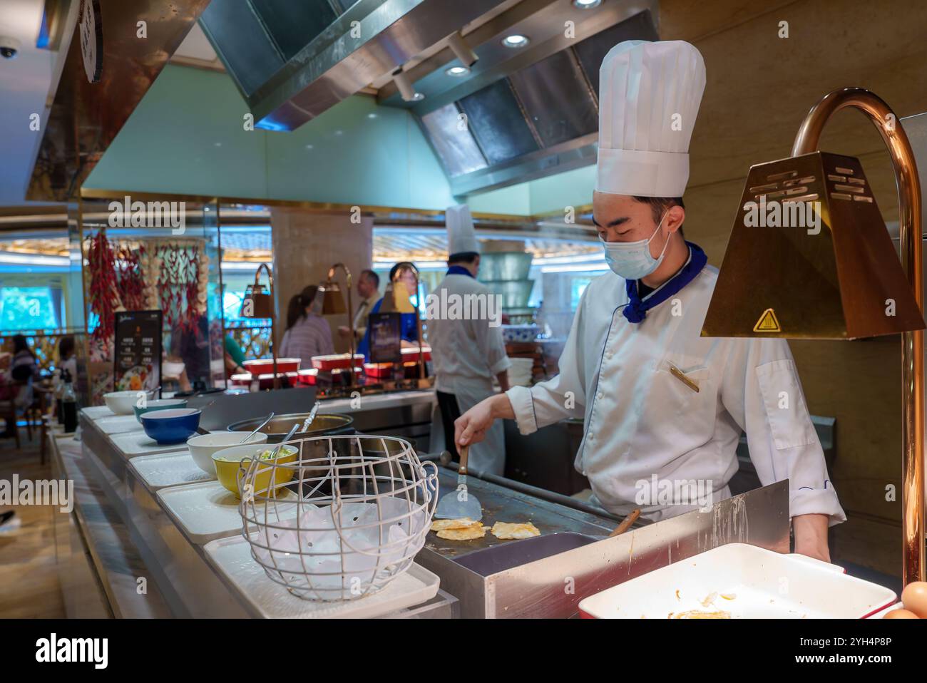 Chef in Traditional Uniform Cooking in Modern Shanghai Kitchen Stock ...