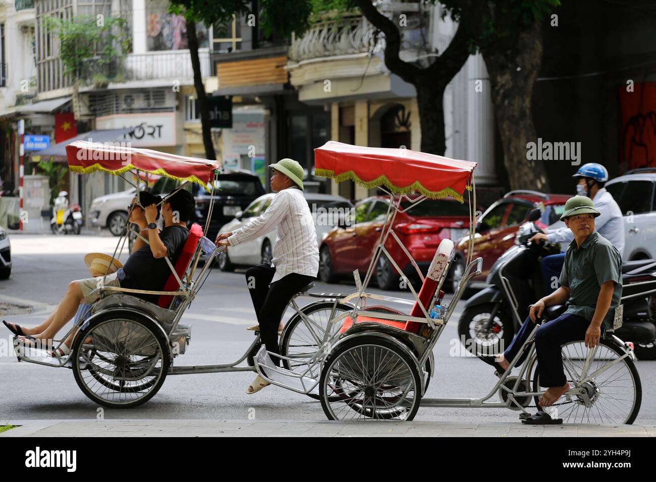 Hanoi, Vietnam - July 10, 2023: Rickshaw drivers work near Dong Kinh ...