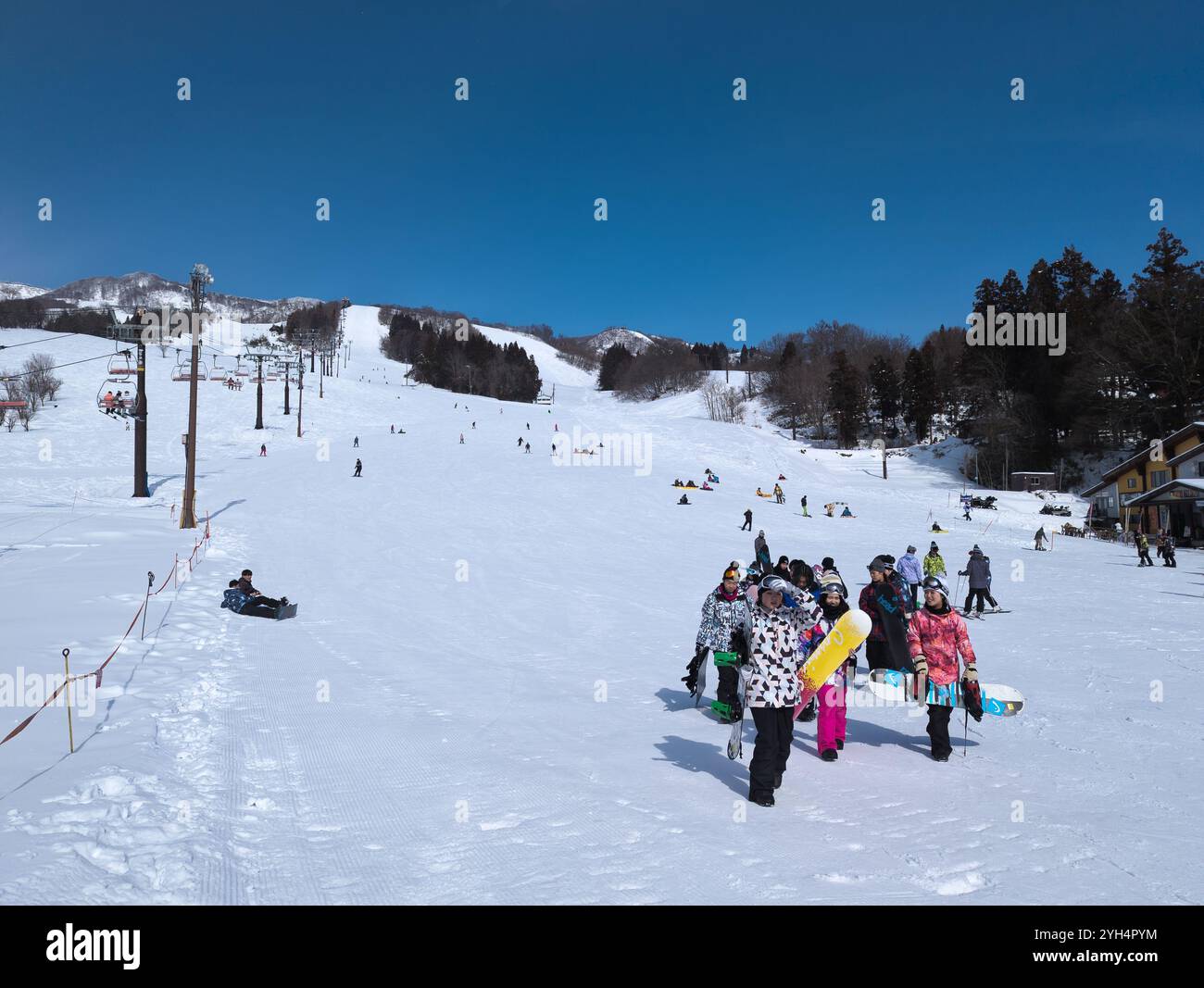 Skiers and snowboarders on the slopes of Togari Onsen resort in Nagano ...