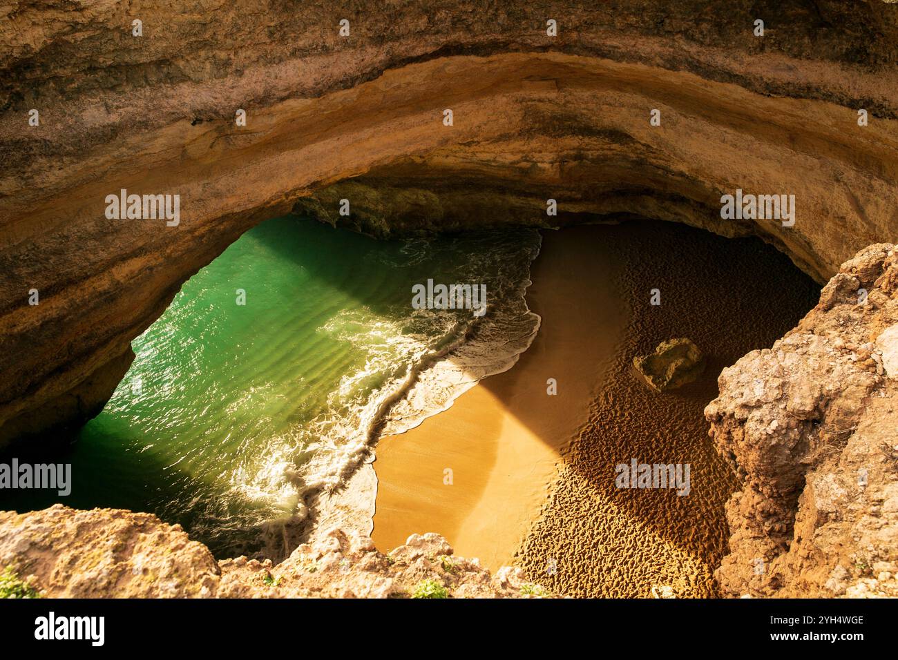 A top-down view of Benagil Cave in Portugal, revealing turquoise waters ...