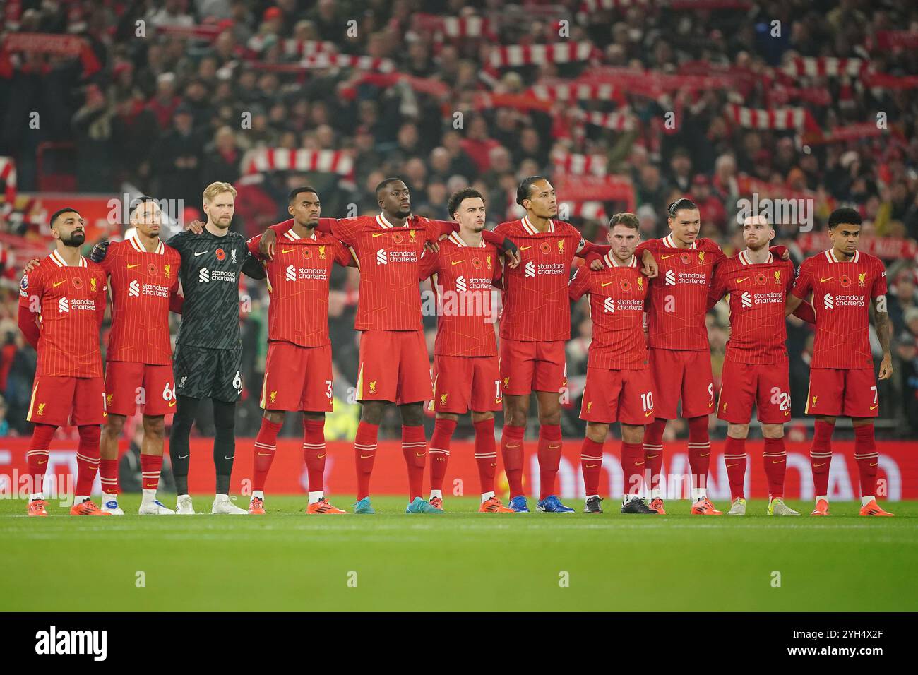 Liverpool players stand as The Last Post is performed to mark ...