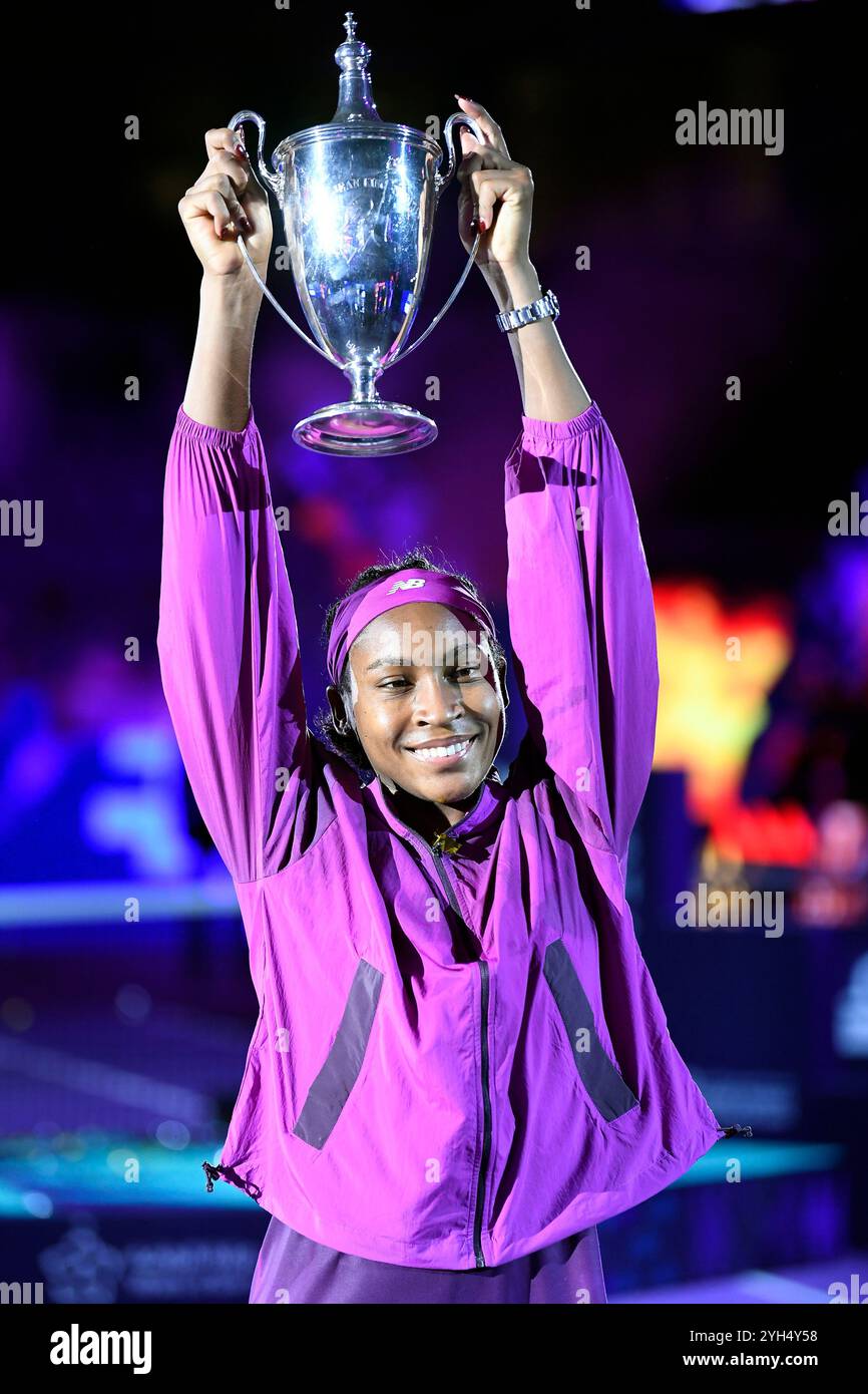 Coco Gauff of the U.S. holds her trophy after winning against China's Qinwen Zheng in their ...