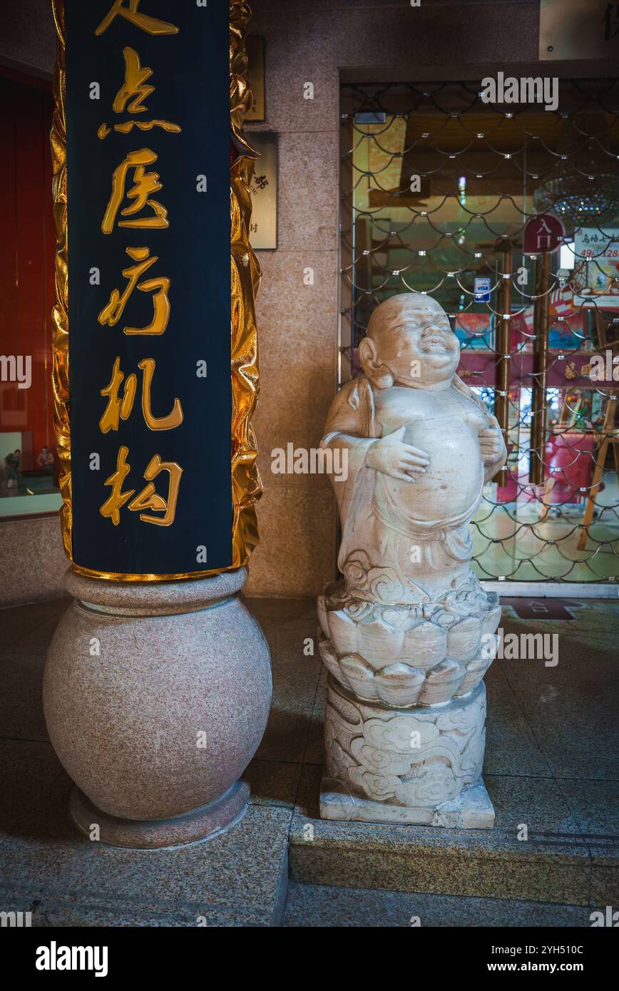 Stone Statue of Traditional Chinese Deity at Building Entrance in ...