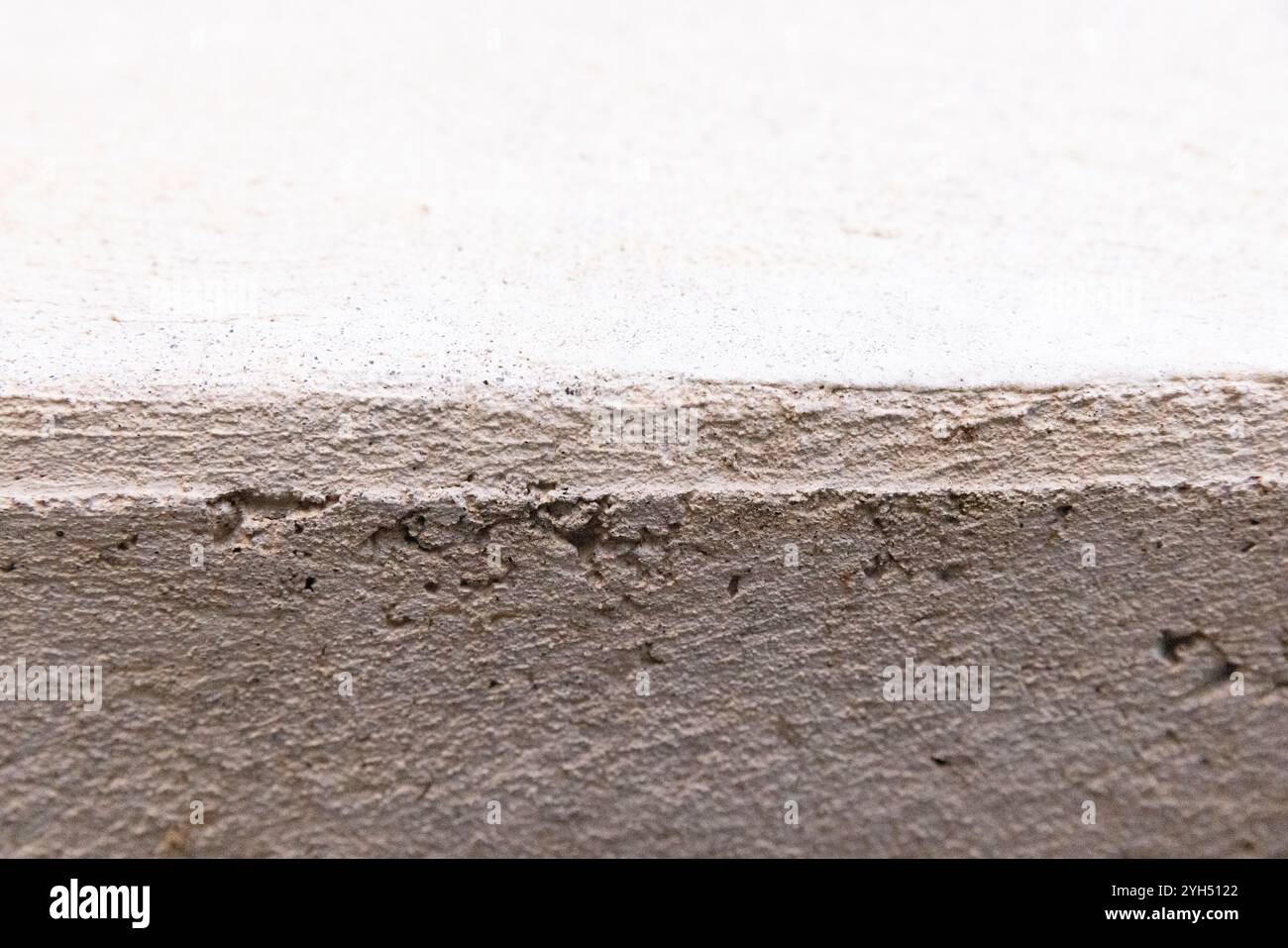 Close up photo of a granulated concrete rock texture split with ...