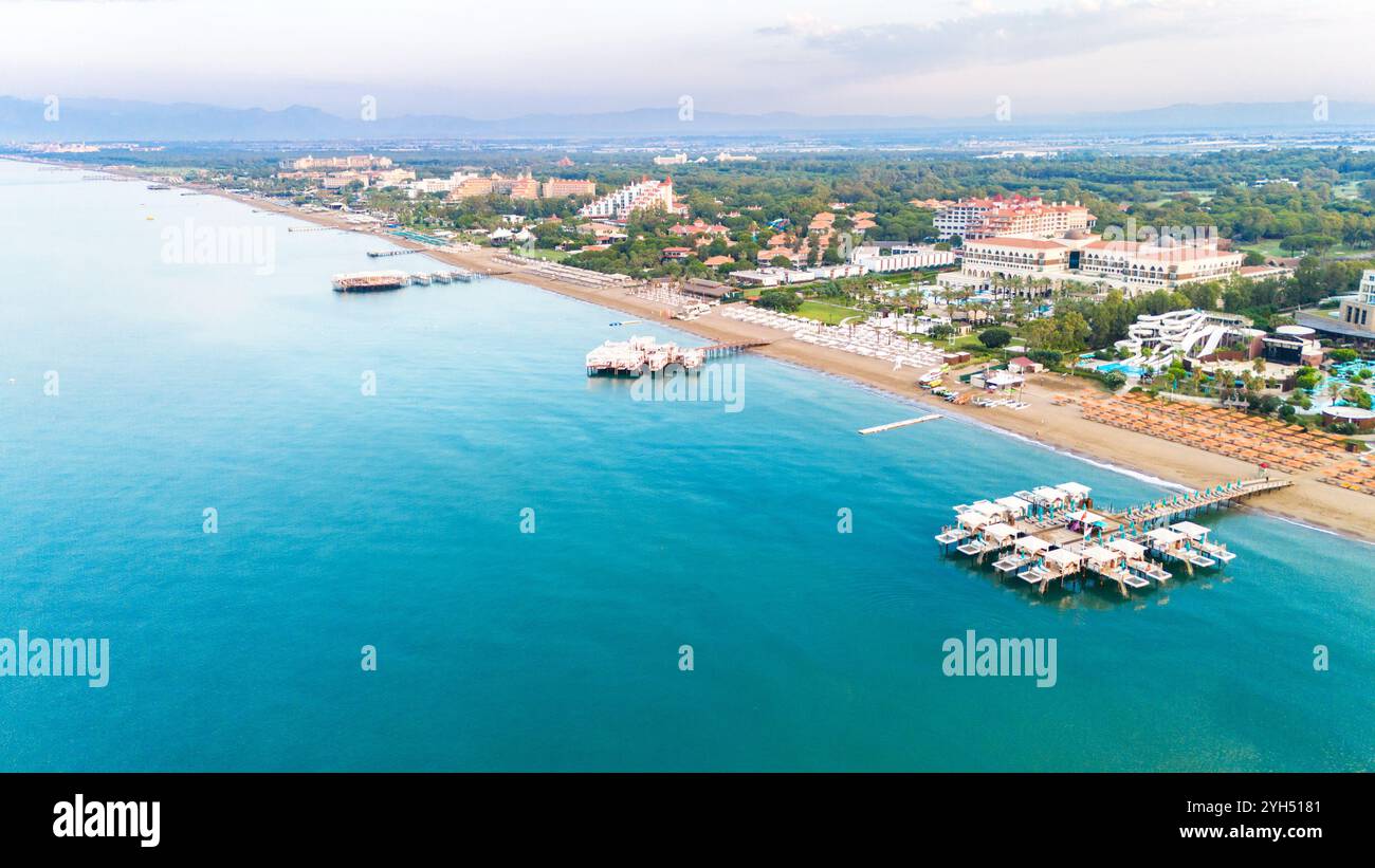 Aerial view of a luxurious beachfront resort with scenic piers and blue ...