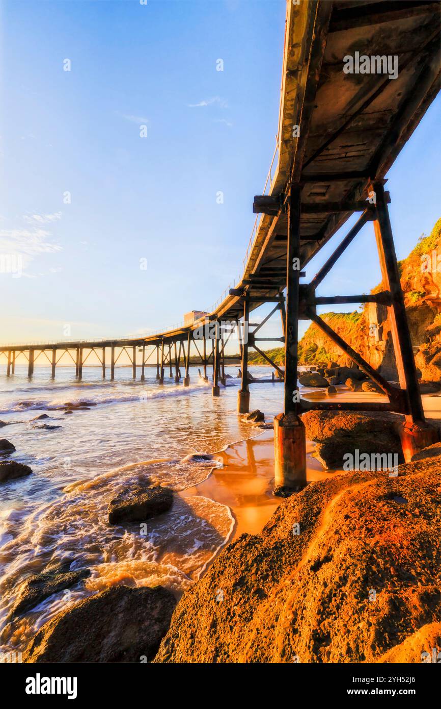 Historic timber jetty underneath view on Pacific coast of Australia at ...