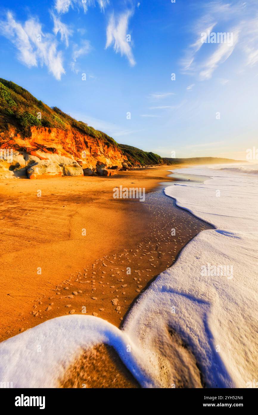 Smooth wave on black sand of Middle Camp beach in Catherine Hill bay of ...