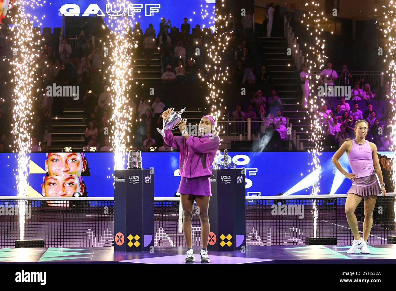 Coco Gauff of the U.S. holds her trophy next to China's Qinwen Zheng ...