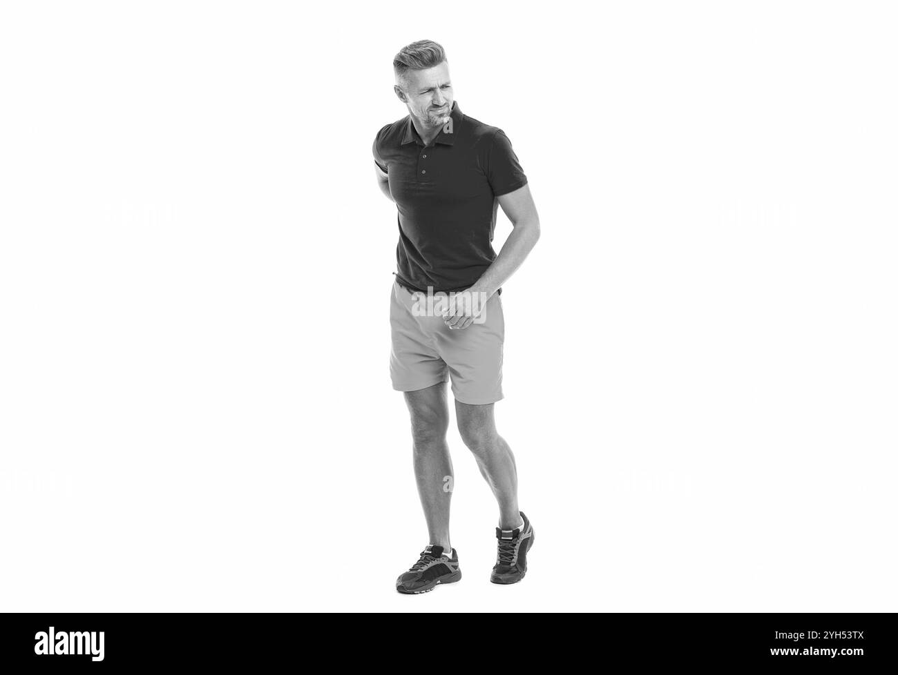 sport man suffering from a backache. sport man massages his lower back ...