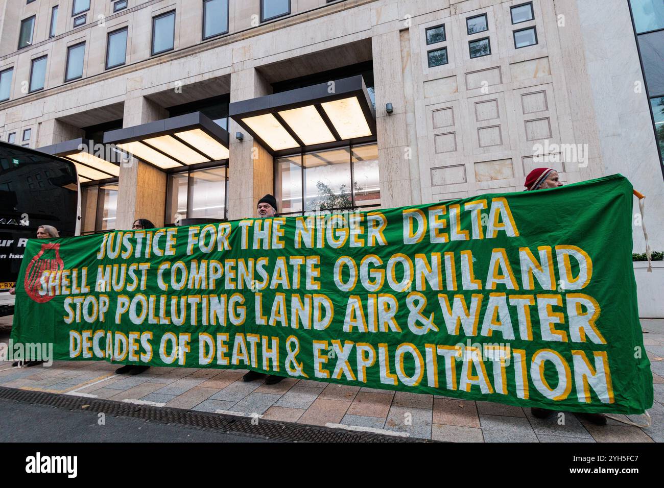 London, UK. 9th November, 2024. Environmental activists stand behind a ...